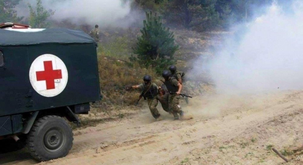 Militants shell Ukrainian outpost near Troitske, four troops wounded ...